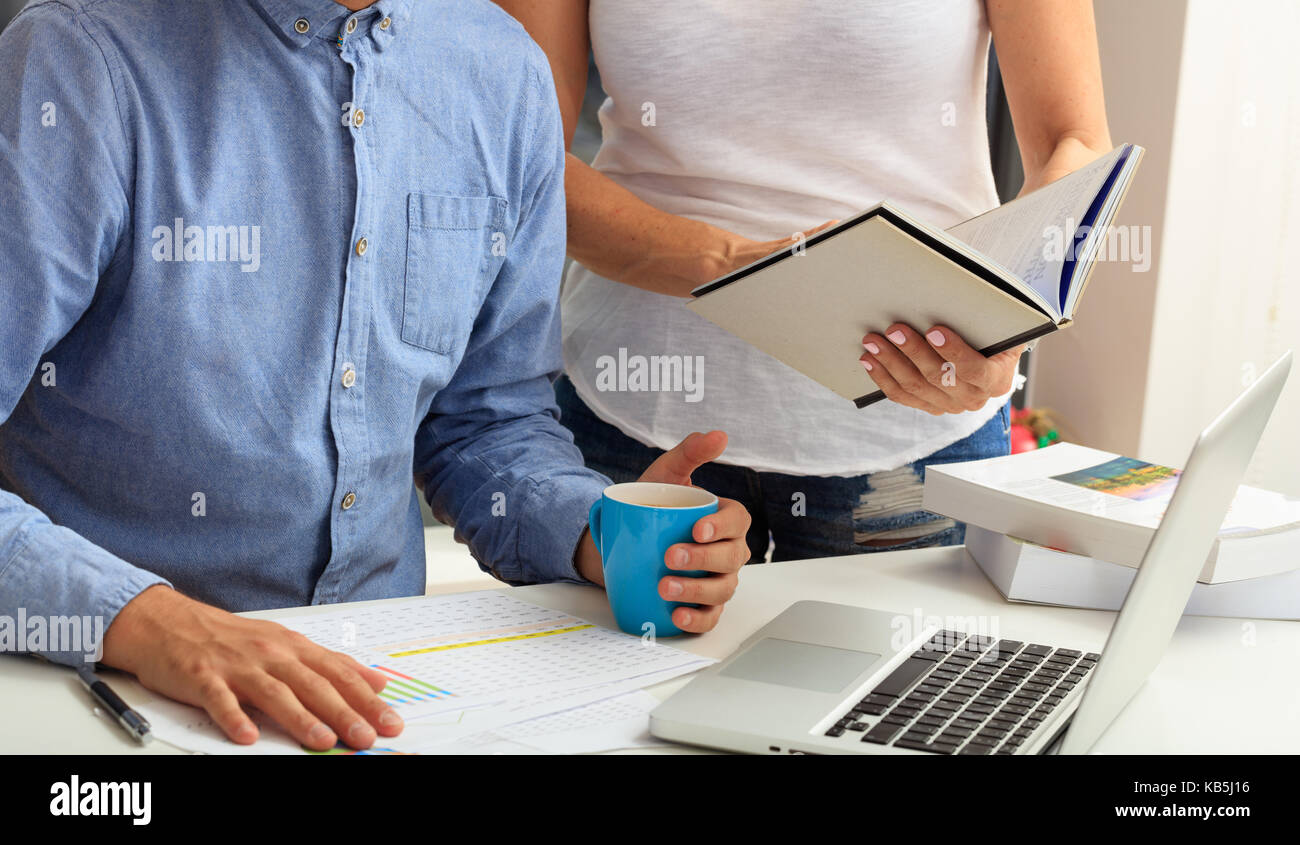 Man and his assistant working in an office background Stock Photo - Alamy