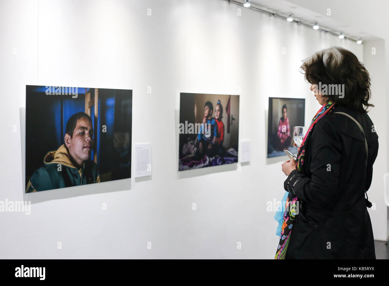 A woman looks at a photograph during an exhibition of Pulitzer prize winning photographer Daniel ...