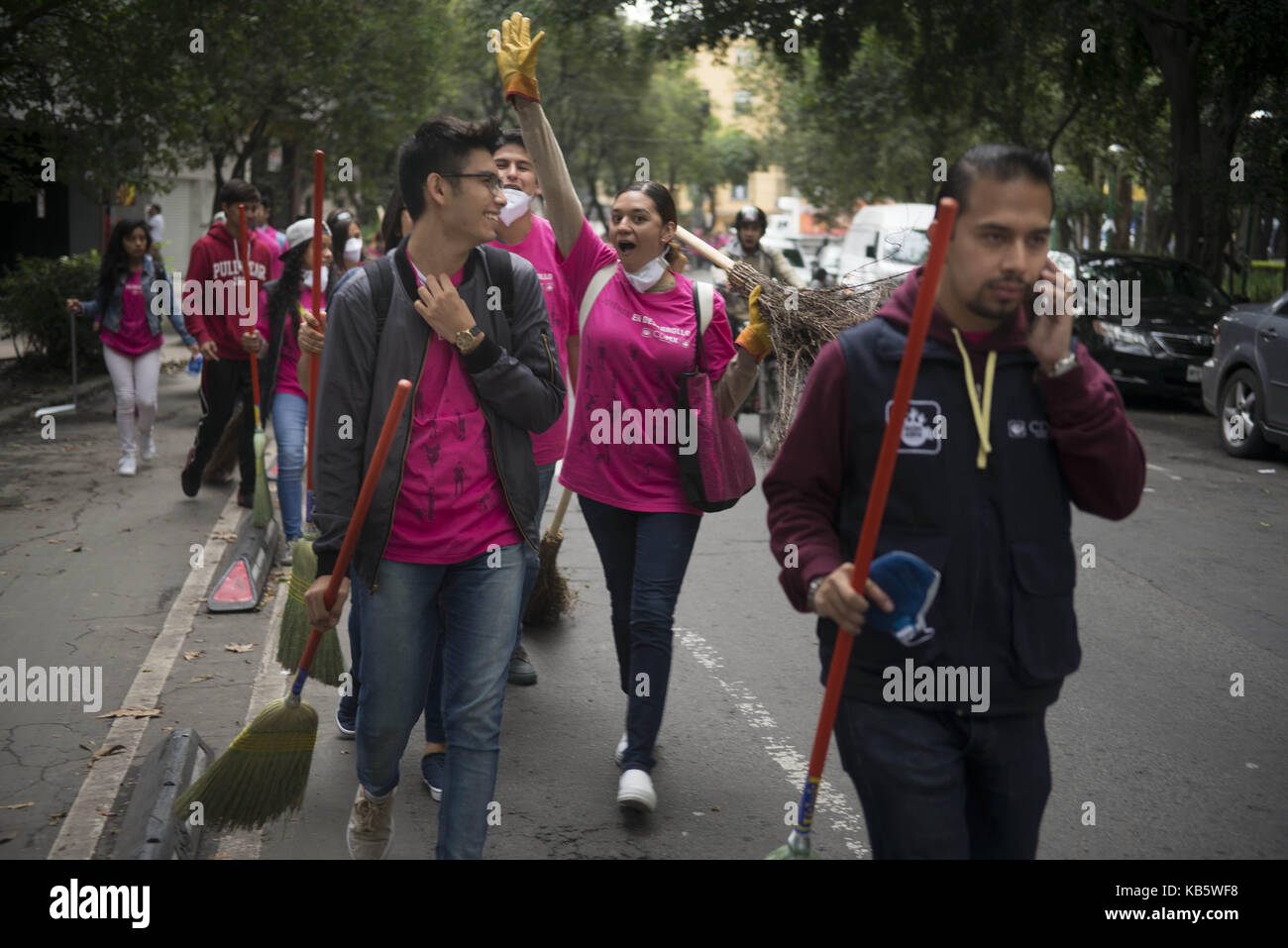 Volunteers help clean up streets in areas affected by the 7.1 ...
