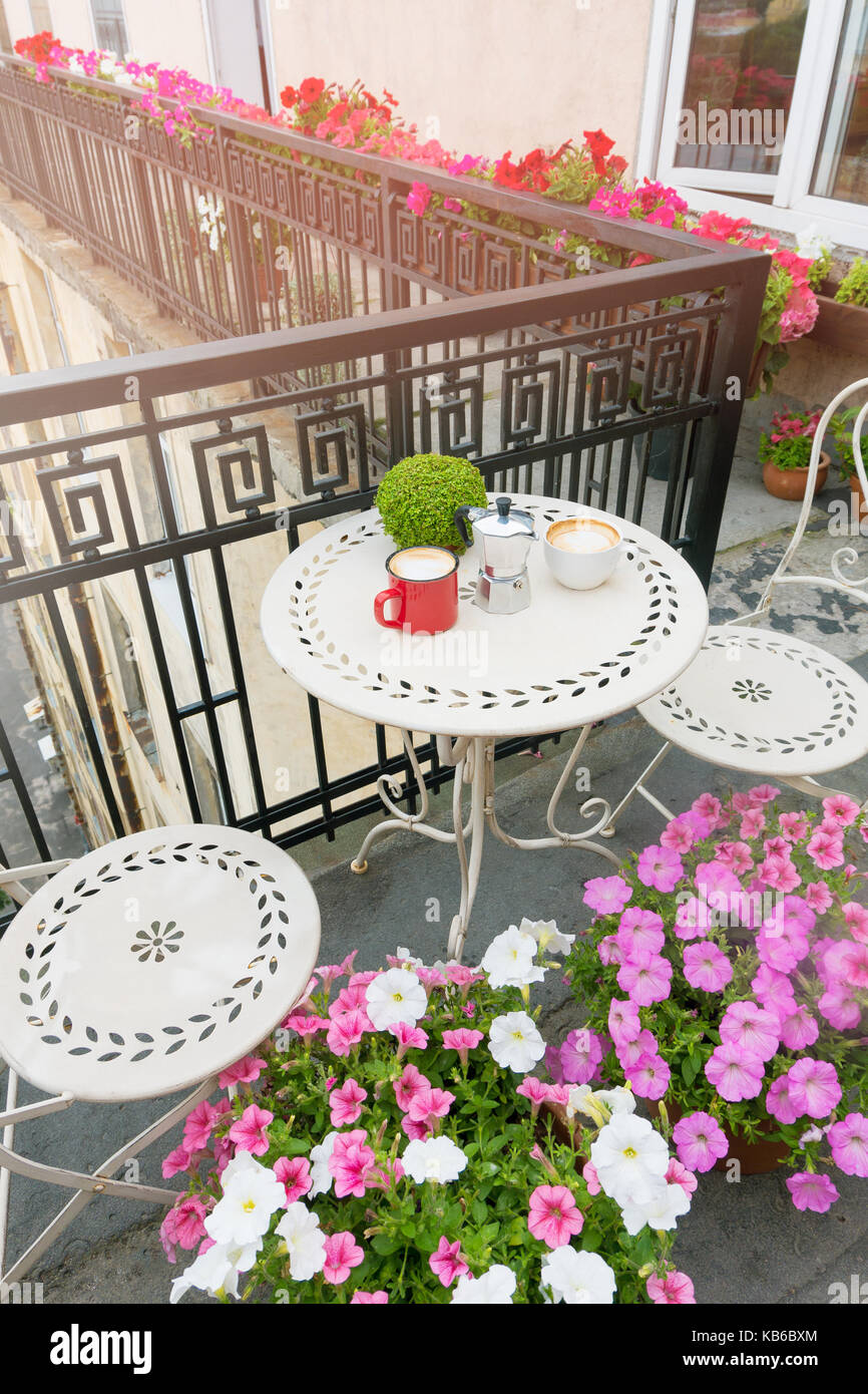 Beautiful balcony with coffee table Stock Photo - Alamy