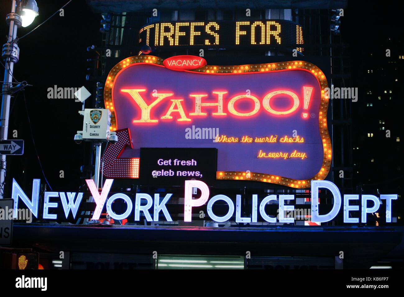 Neon sign of Yahoo, above the neon sign of the NYPD at Times Square in ...