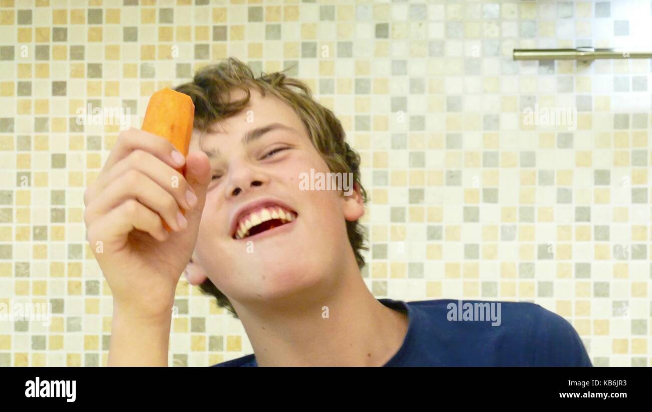 Boy biting carrot hi-res stock photography and images - Alamy