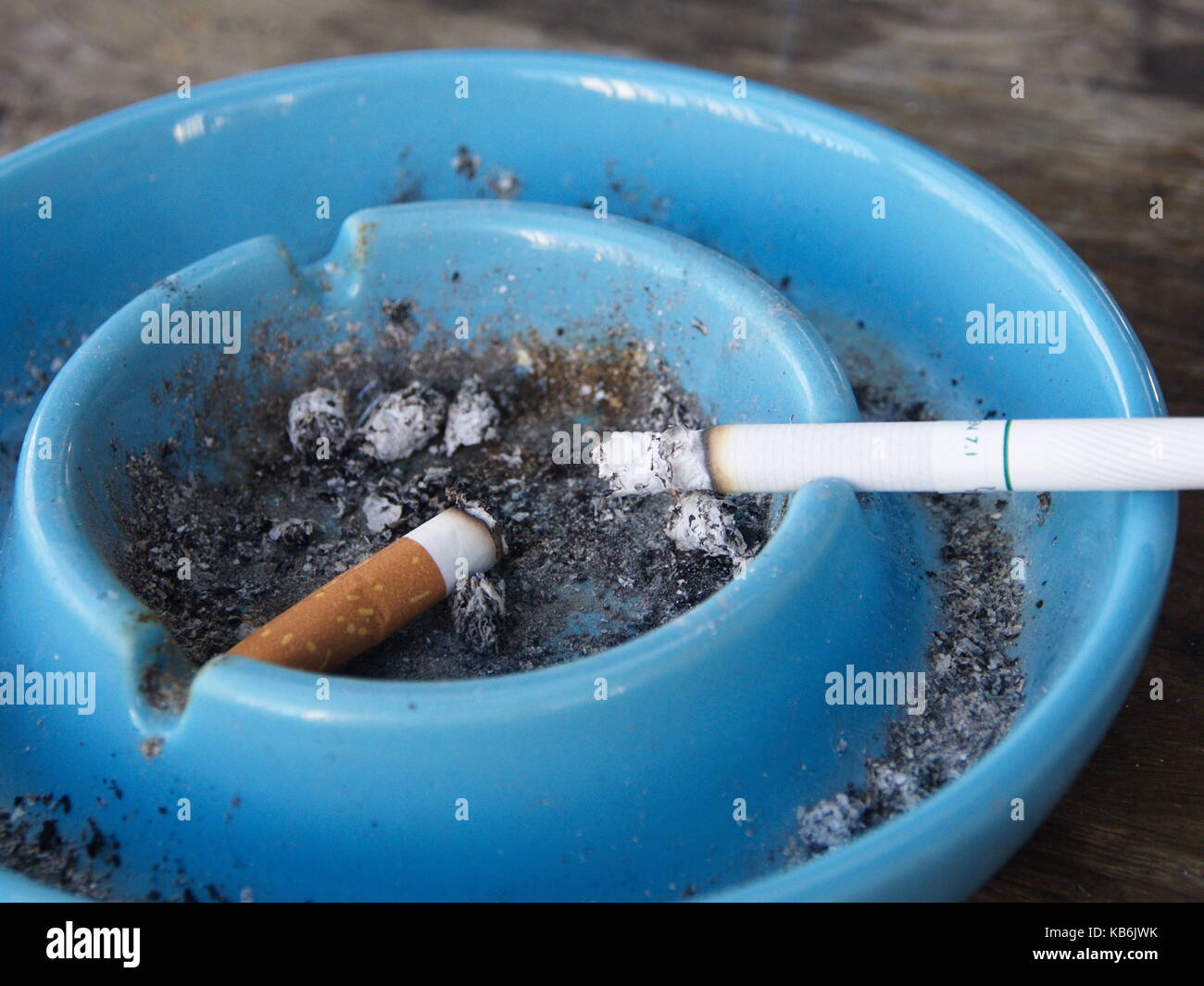 an Ashtray and Cigarette. a Smoking Place with a wooden table Stock ...