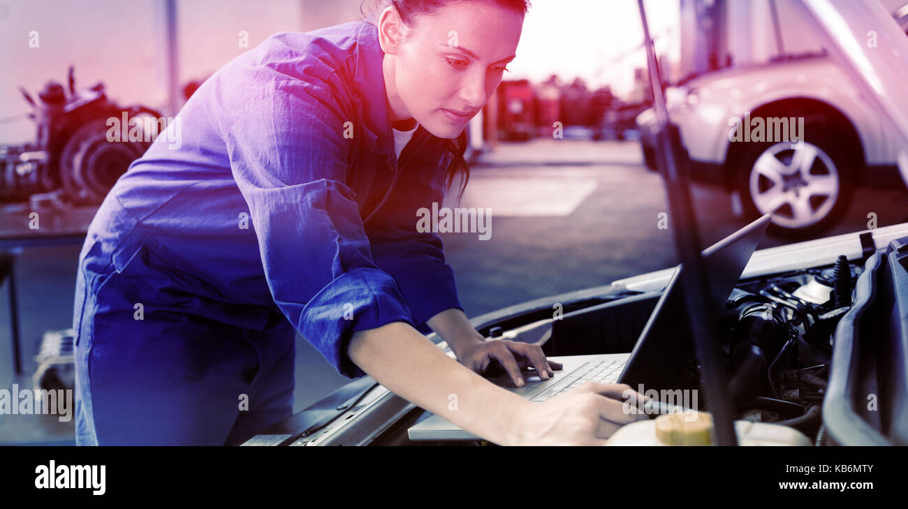 Mechanic using laptop on car at the repair garage Stock Photo - Alamy