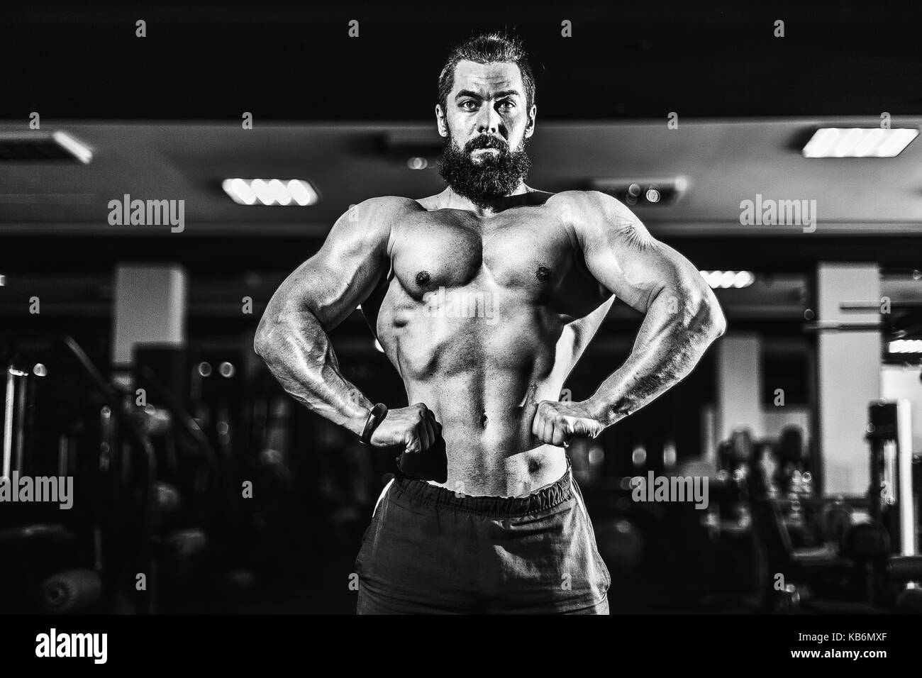 Athlete muscular bodybuilder man posing in gym Stock Photo - Alamy