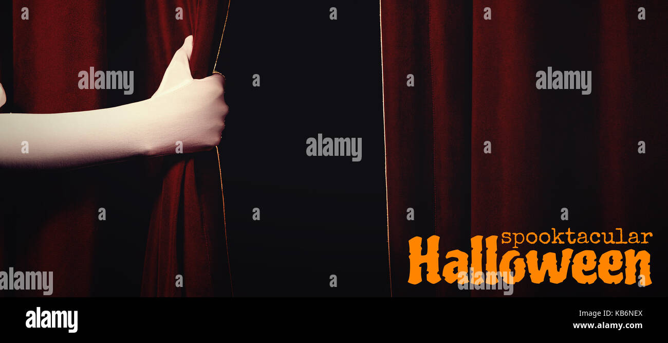 Graphic image of spooktacular Halloween text against cropped hand ...