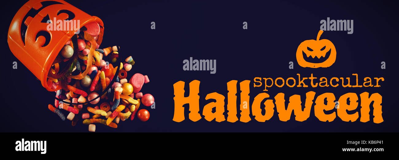 Graphic image of spooktacular Halloween text against bucket with ...