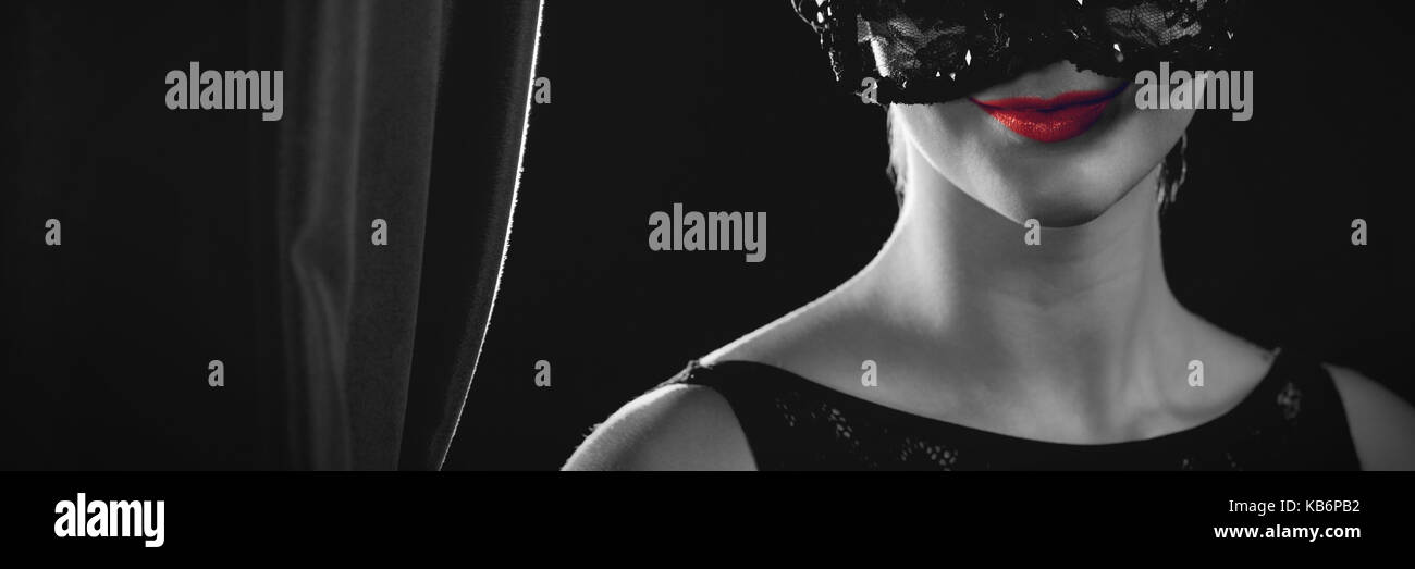 Portrait of woman in masquerade mask by curtain at stage Stock Photo ...