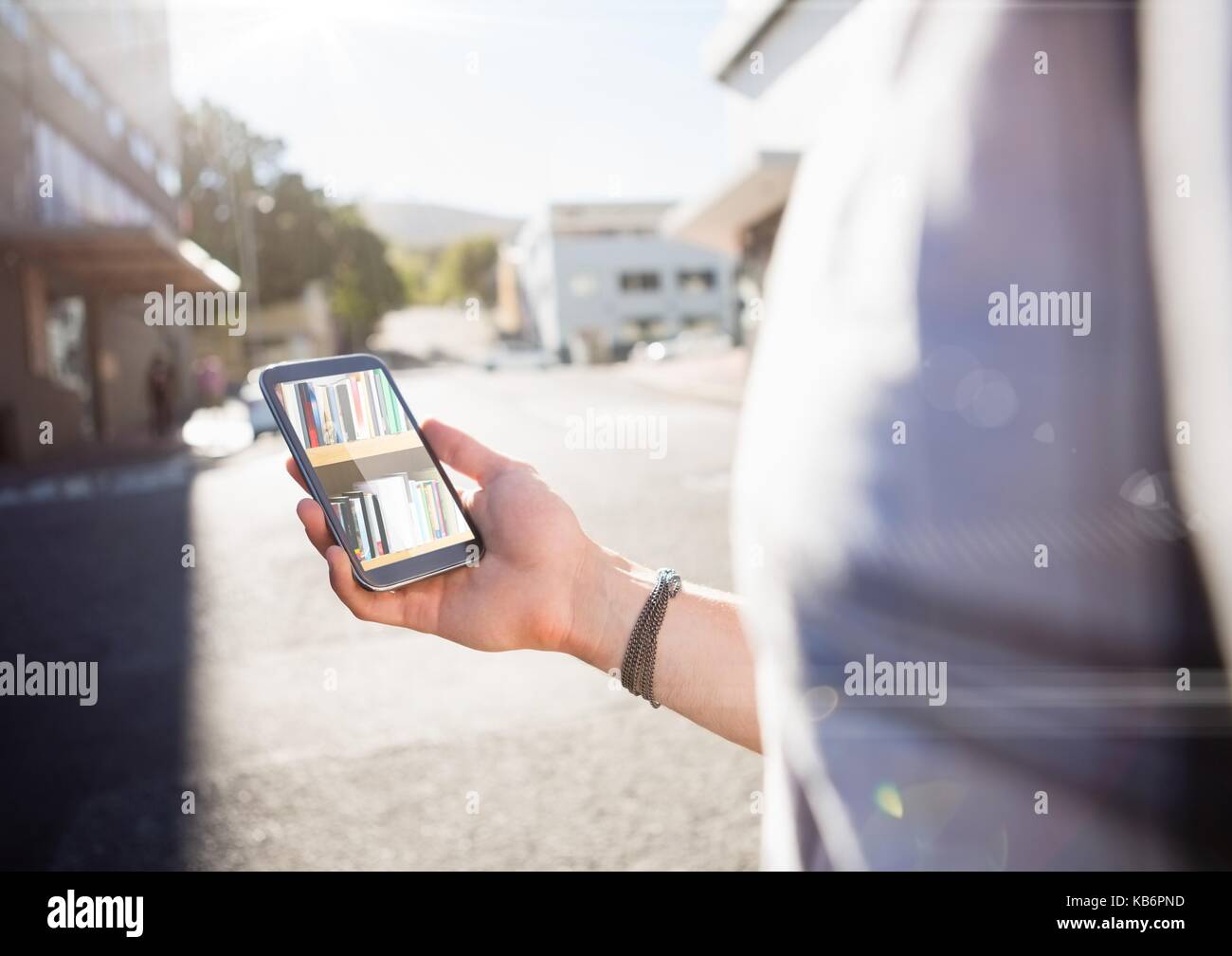 Digital composite of Bookshelf on mobile-phone screen Stock Photo - Alamy