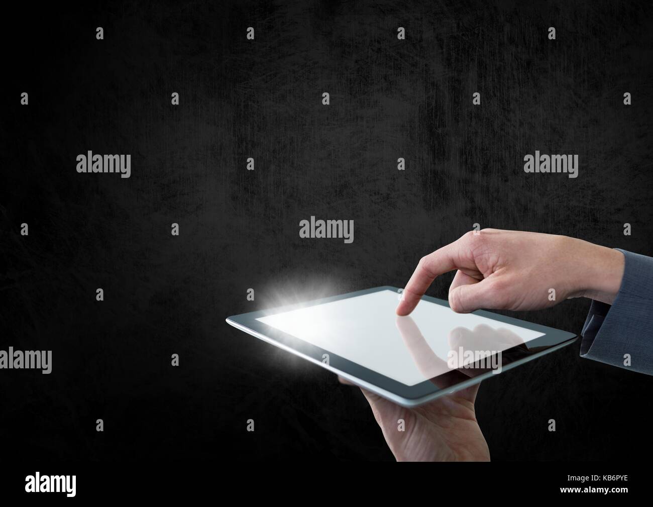 Digital composite of Hand holding tablet with glow Stock Photo - Alamy