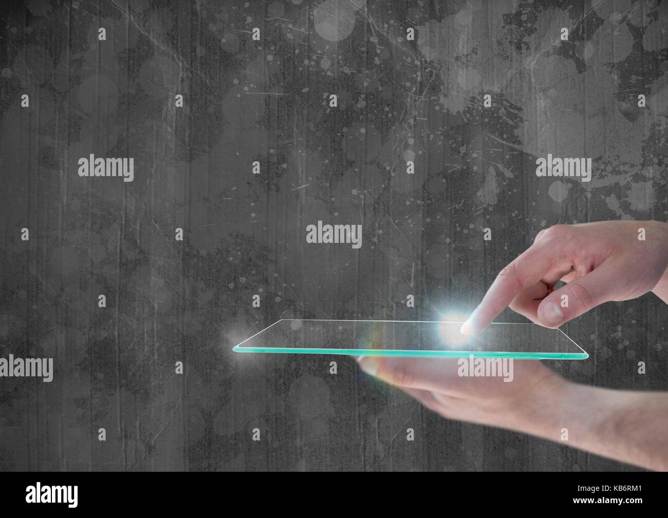 Digital composite of Hand holding tablet with glow Stock Photo - Alamy