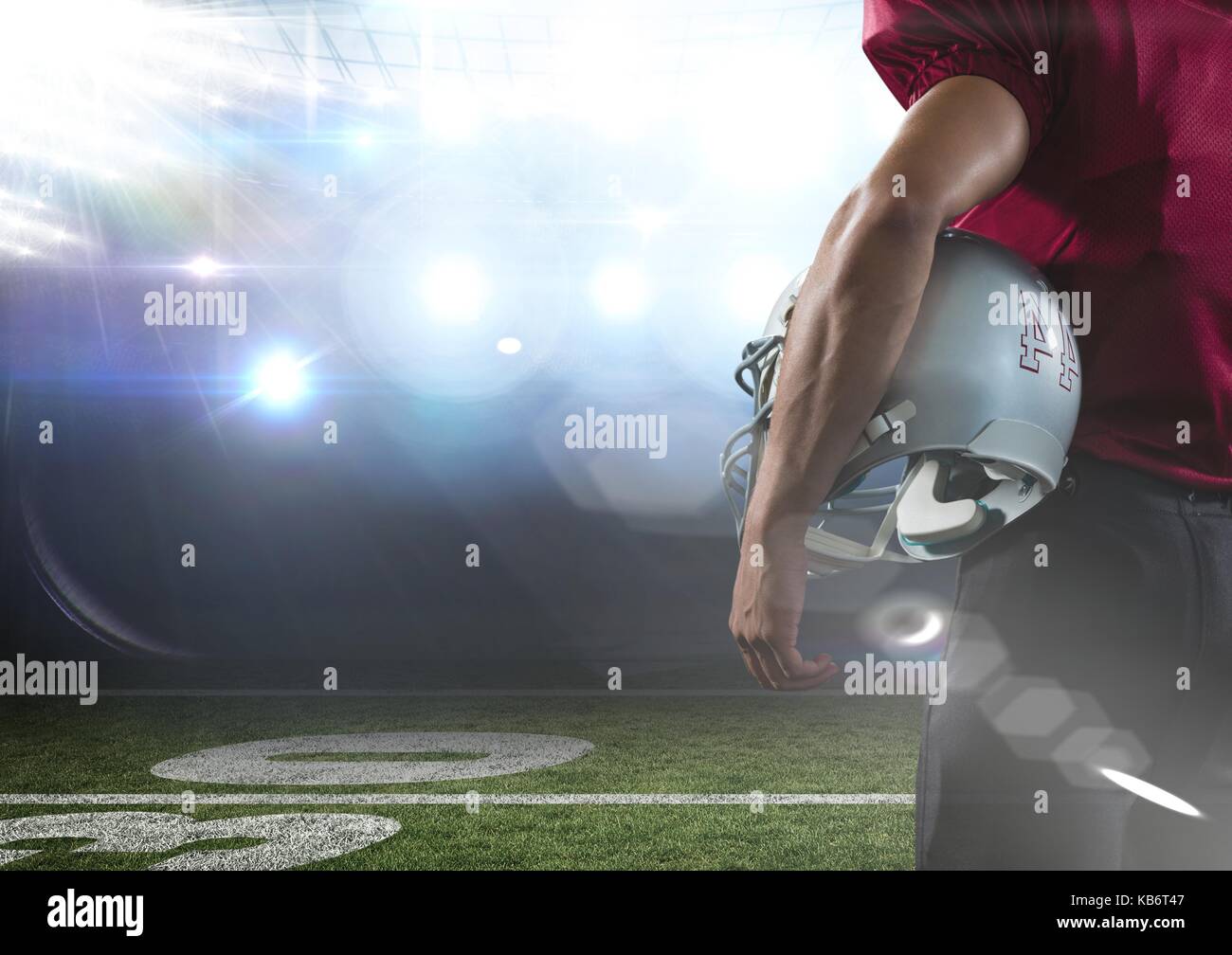 Digital composite of american football player standing in stadium rear ...