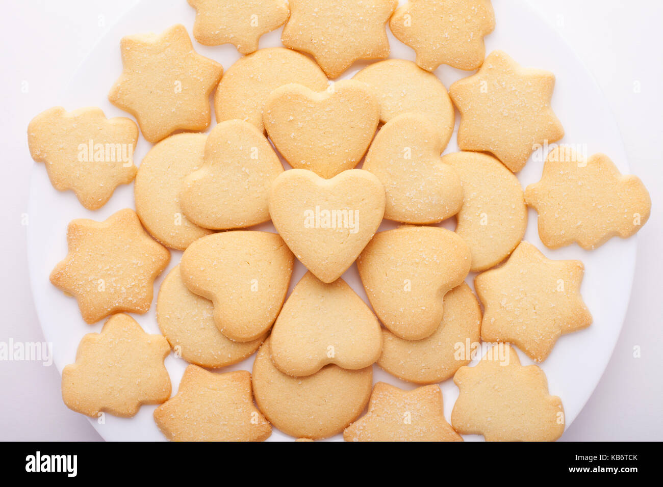 cookies with different shapes on plate isolated on white background ...
