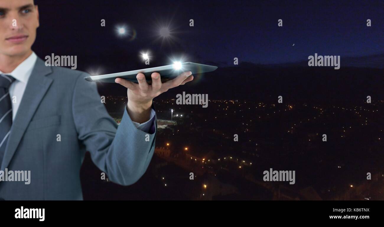 Digital composite of Hand holding tablet with glow Stock Photo - Alamy