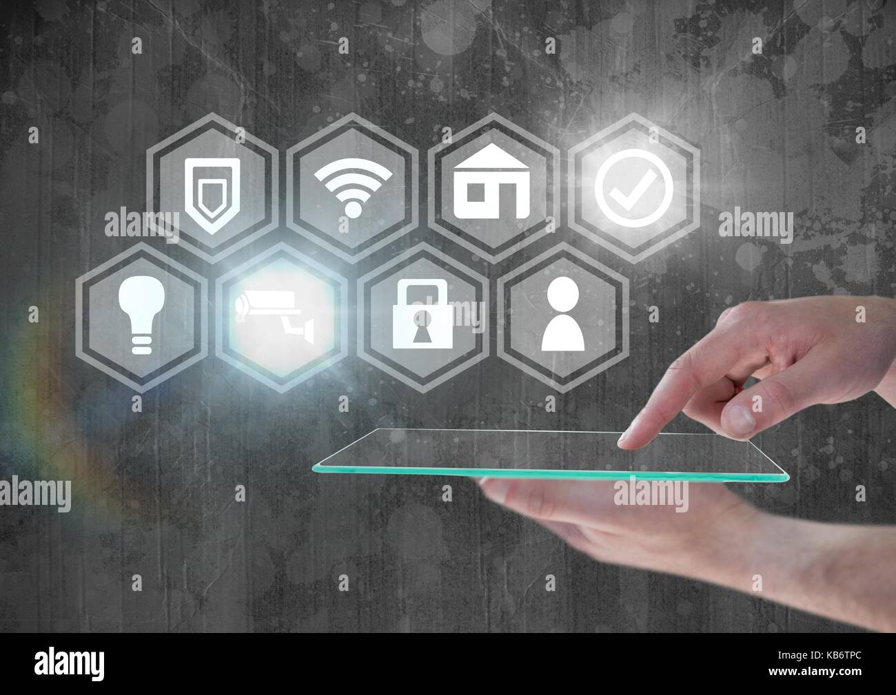Digital composite of Hand holding glass tablet with icons interface of ...