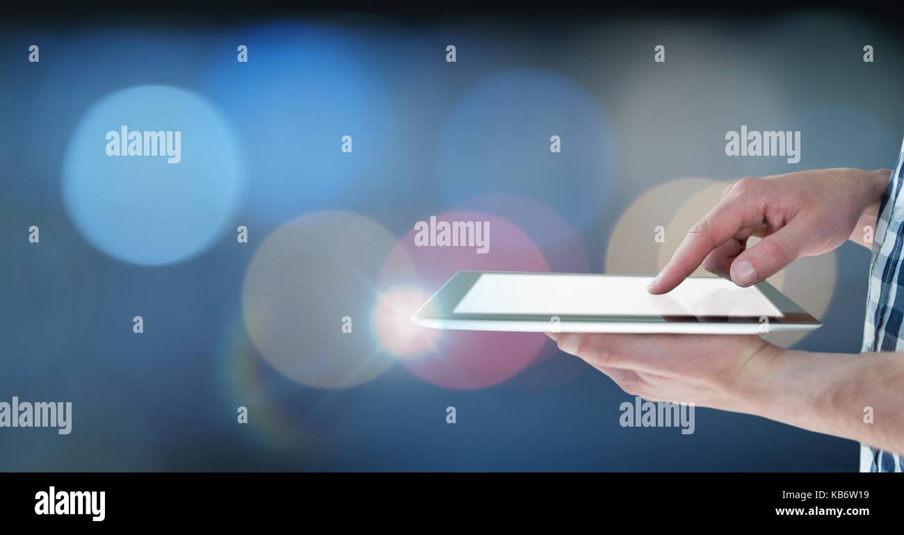 Digital composite of Hand holding tablet with glow Stock Photo - Alamy