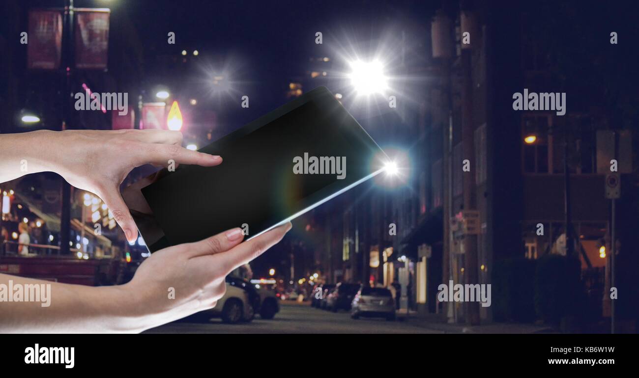 Digital composite of Hand holding tablet with glow Stock Photo - Alamy