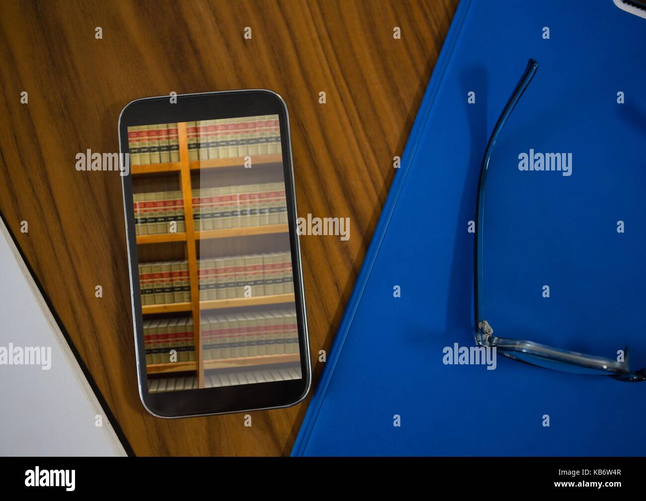 Digital composite of Bookshelf on mobile-phone screen Stock Photo - Alamy