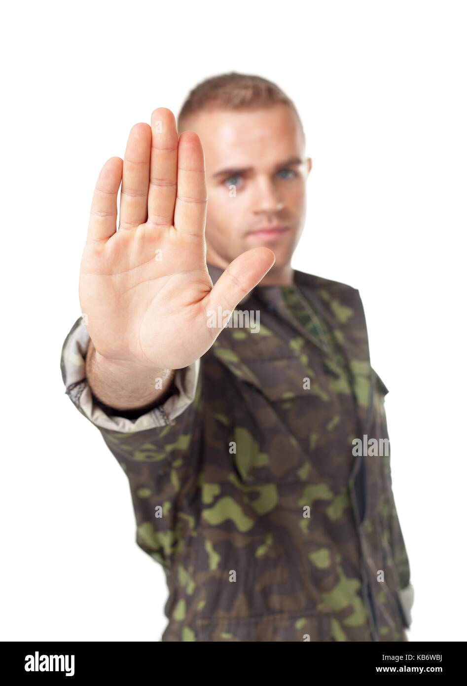 Serious army soldier making stop sign isolated on white background ...