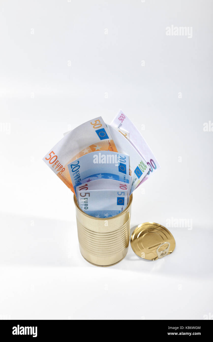 Tin can with money on white background Stock Photo - Alamy