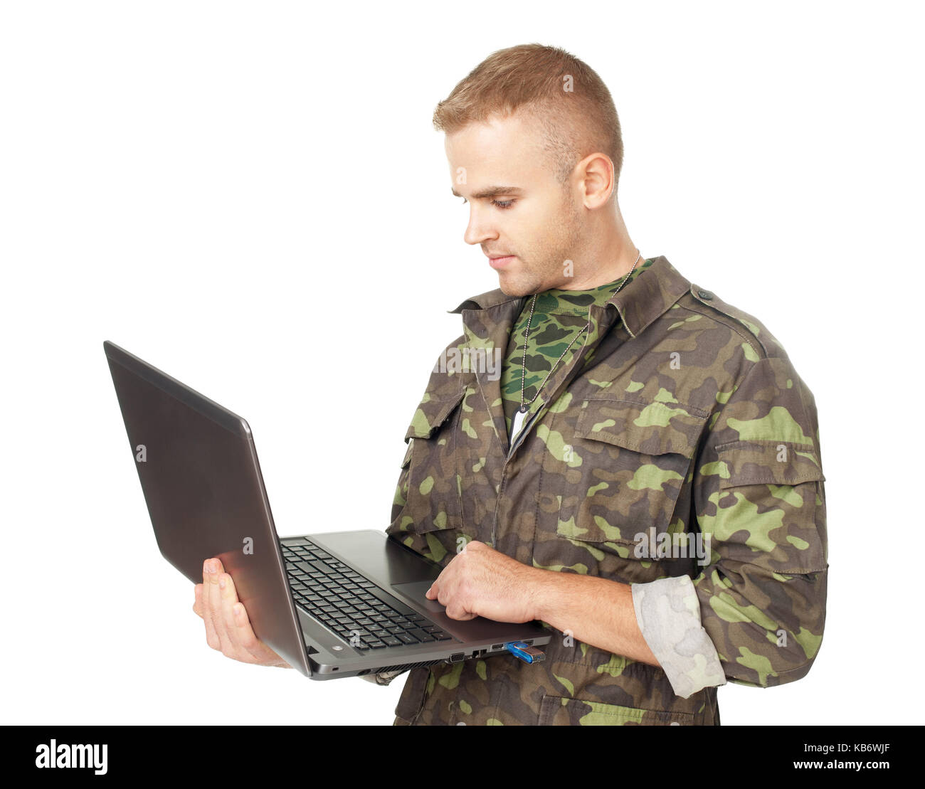 Portrait of young army soldier with a laptop isolated on white ...