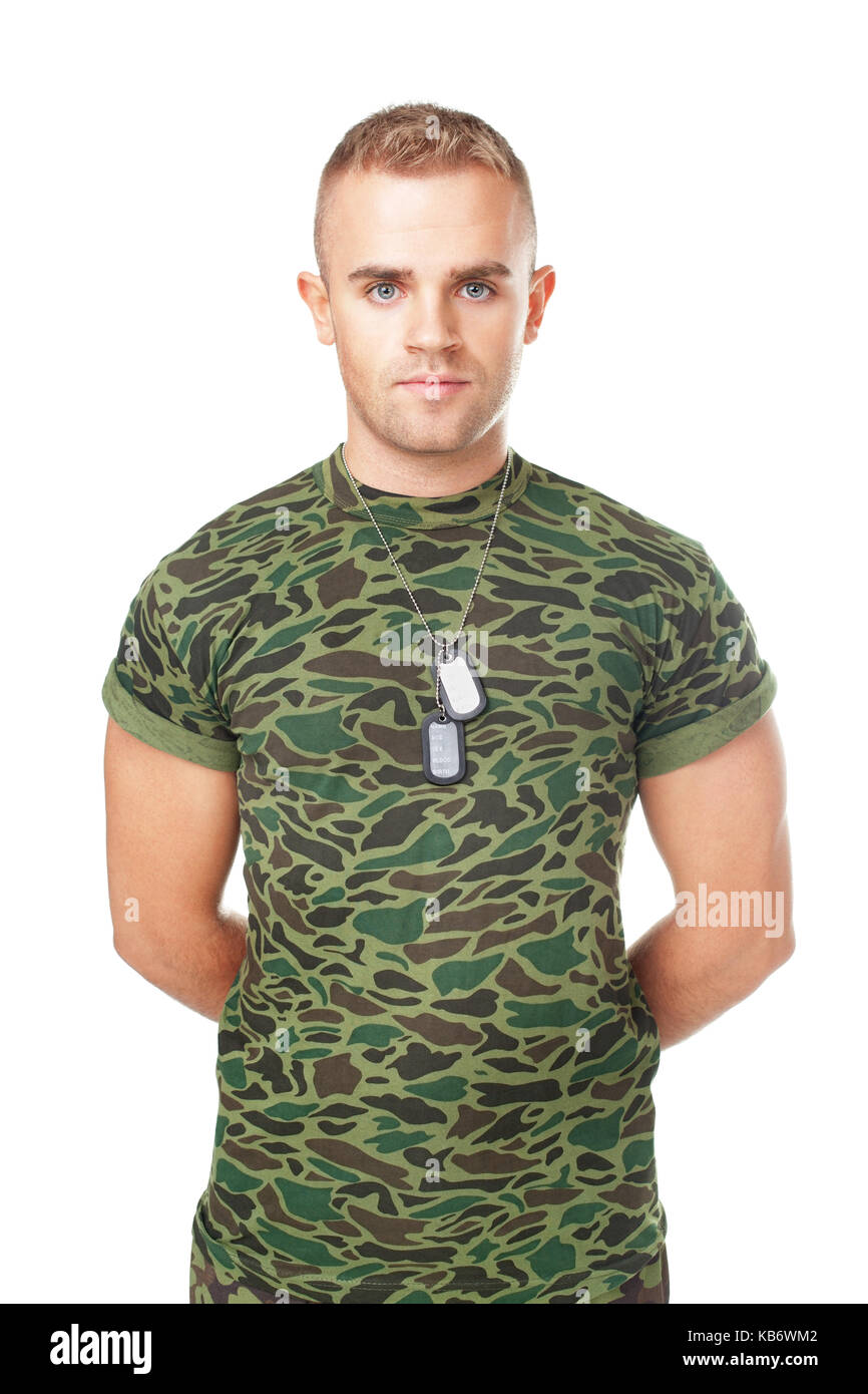 Portrait of young serious army soldier with military ID tags isolated ...