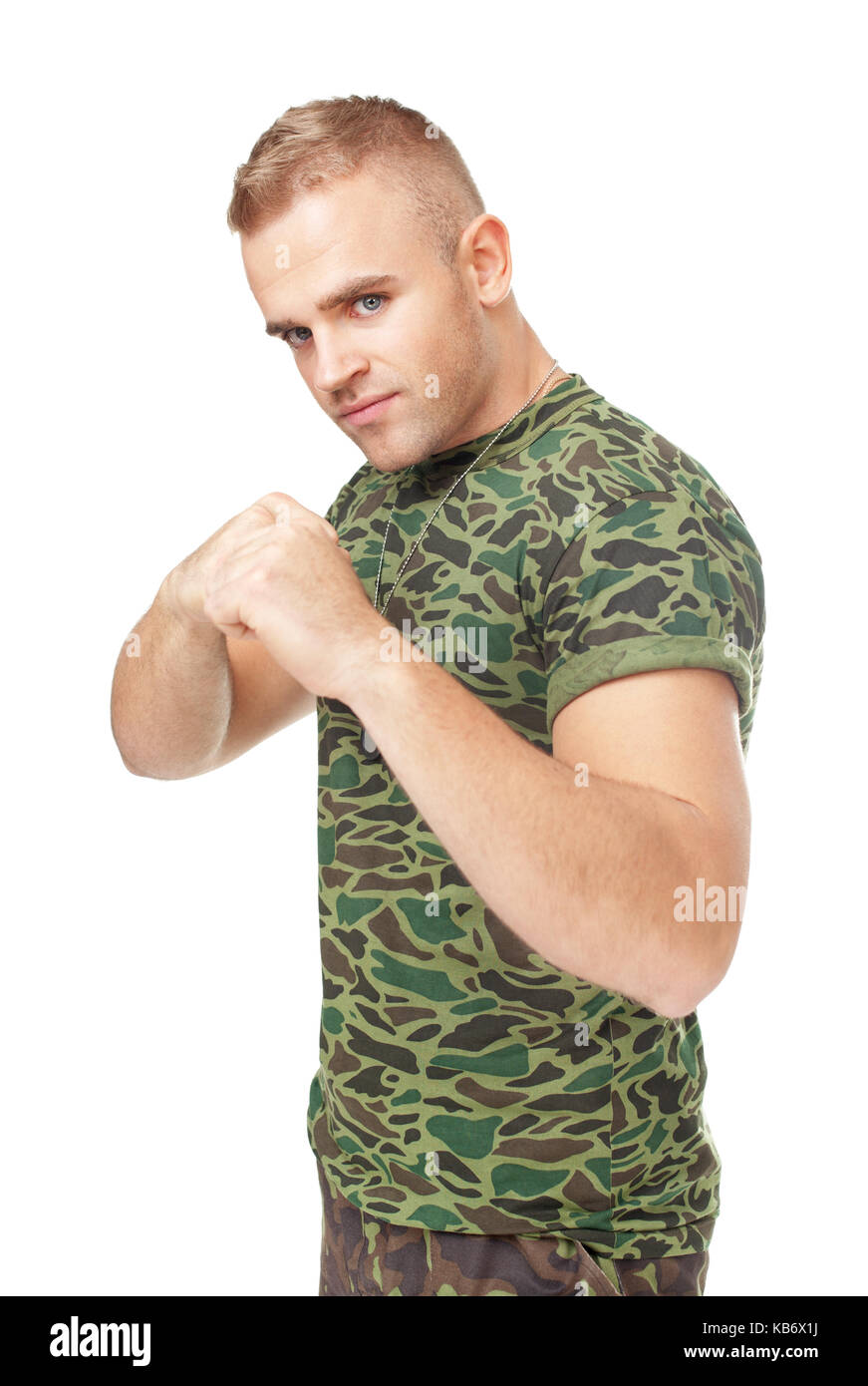 Portrait of young army soldier in fighting stance isolated on white ...