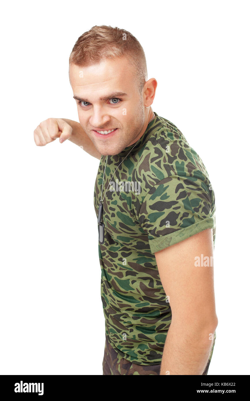 Aggressive young army soldier strikes blow with the clenched fist ...