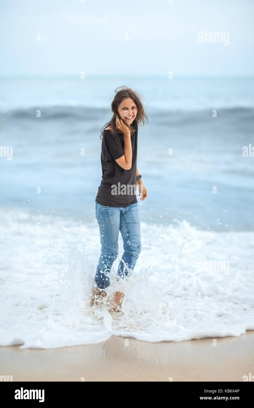 happy beautiful woman enjoying the waves on the tropical sea. Beach fun ...