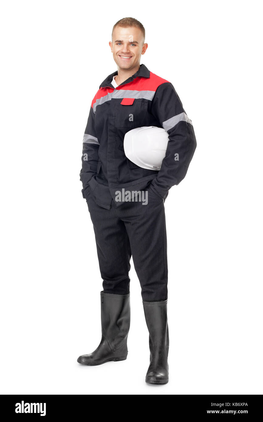 Full length portrait of young smiling engineer holding white helmet ...
