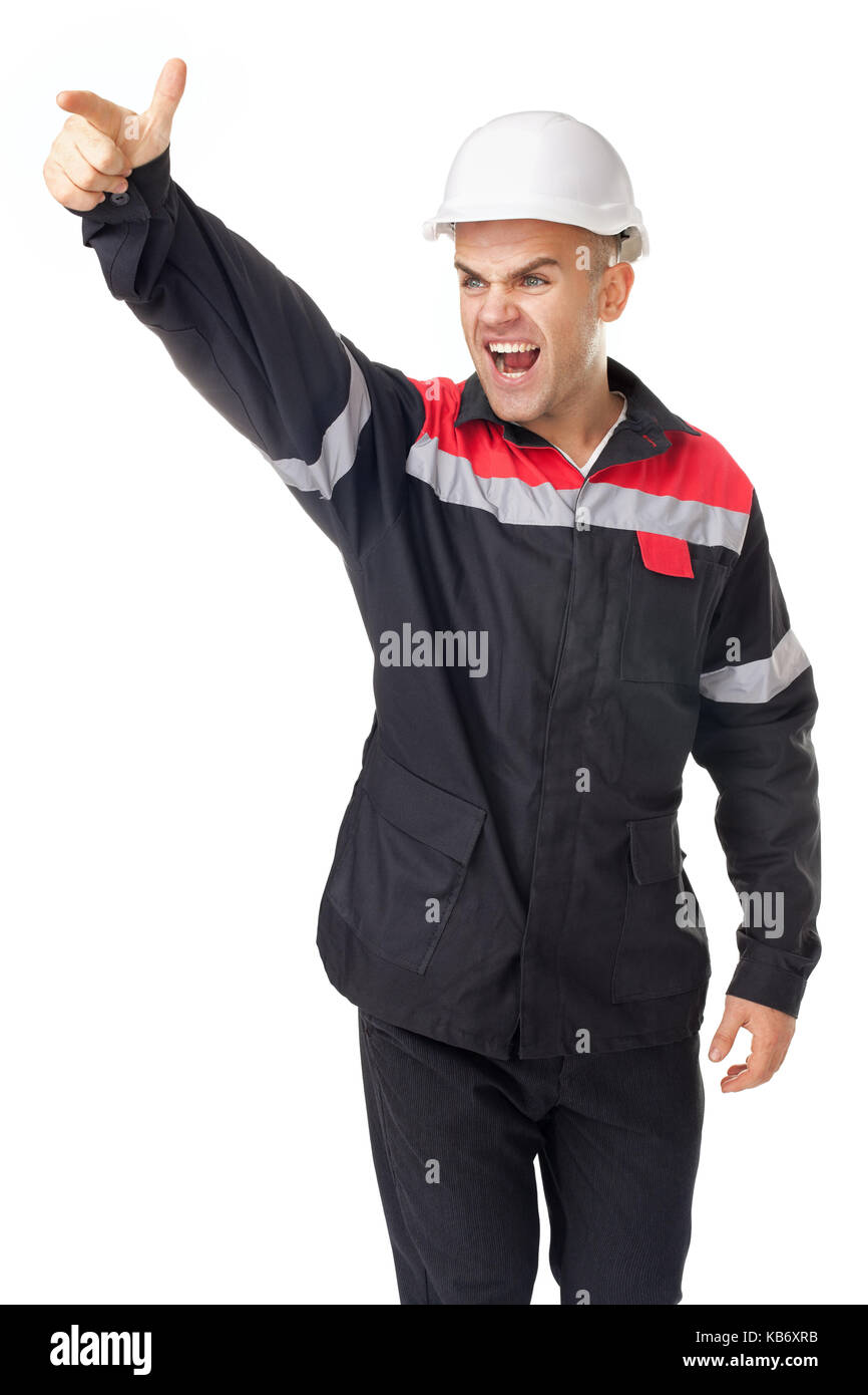 Portrait of young angry engineer shouting and pointing at something ...