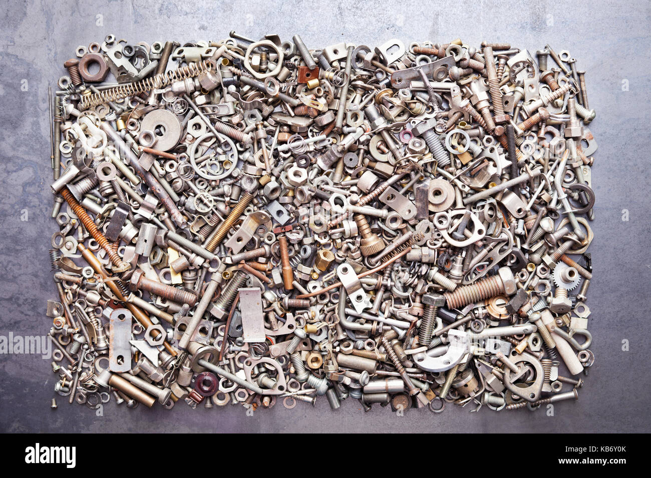 Rectangle from assorted nuts and bolts on metal texture background ...