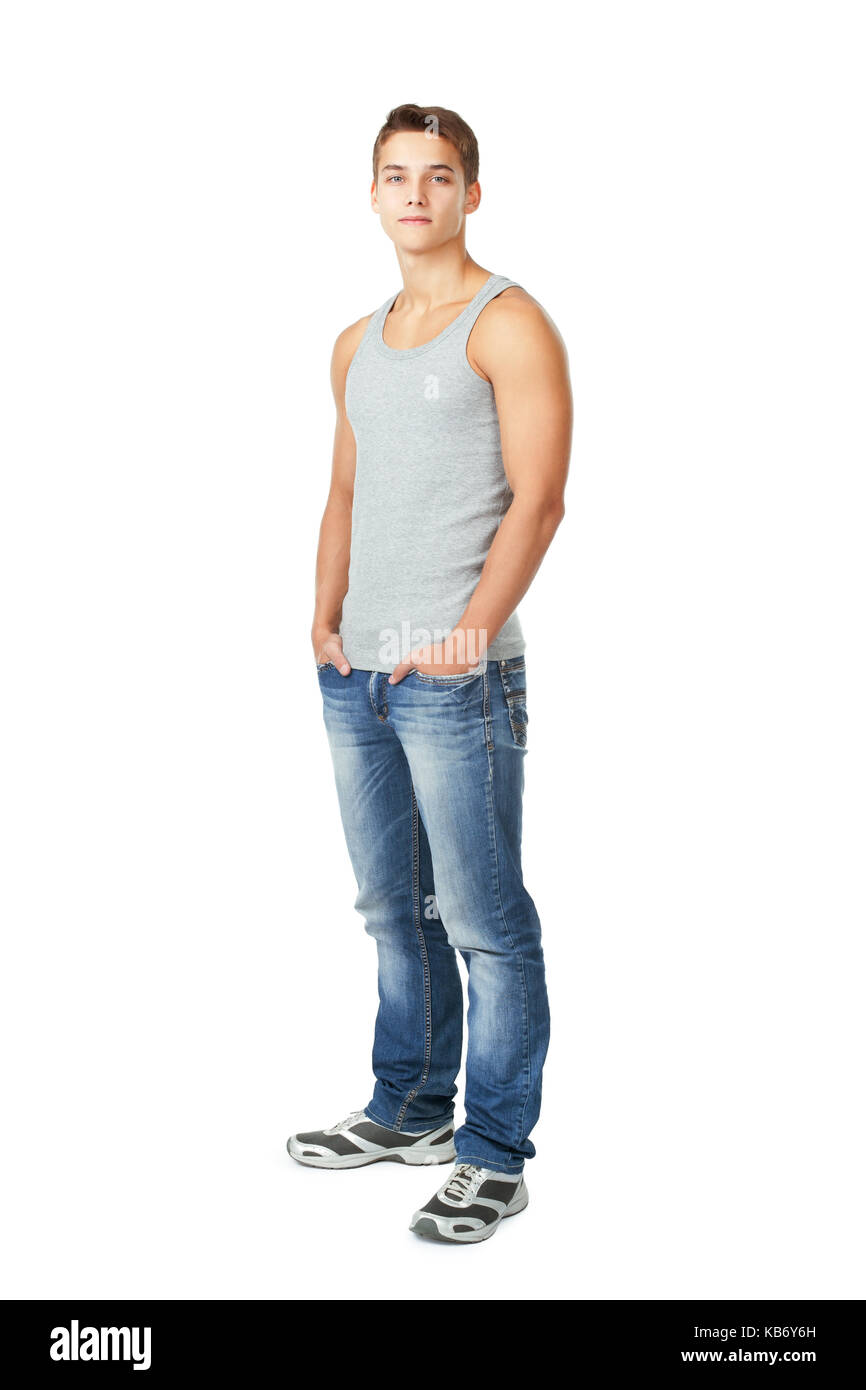 Full length portrait of smiling young man standing with hands in ...