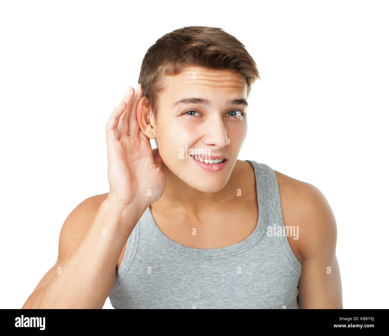 Young man with hand on ear listening carefully isolated on white ...