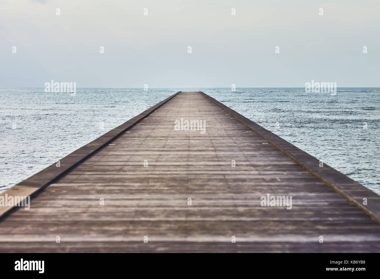 Perspective view of a wooden pier in a tropical sea Stock Photo - Alamy