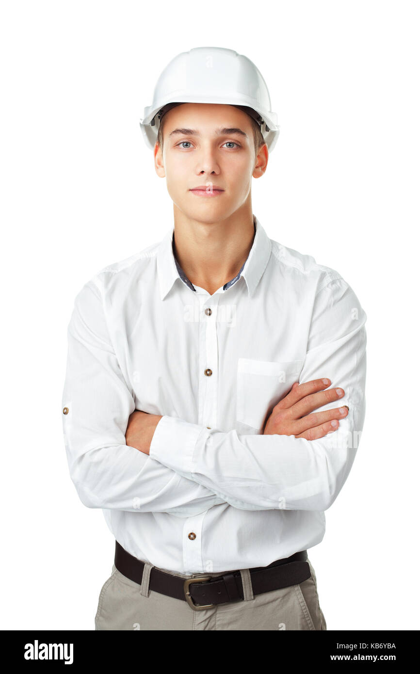 Portrait of young engineer wearing a white helmet standing with hands ...