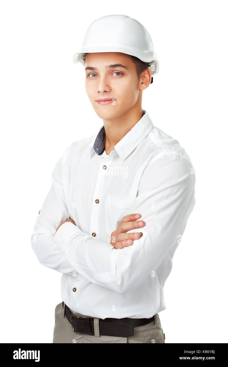 Portrait of young engineer wearing a white helmet standing with hands ...