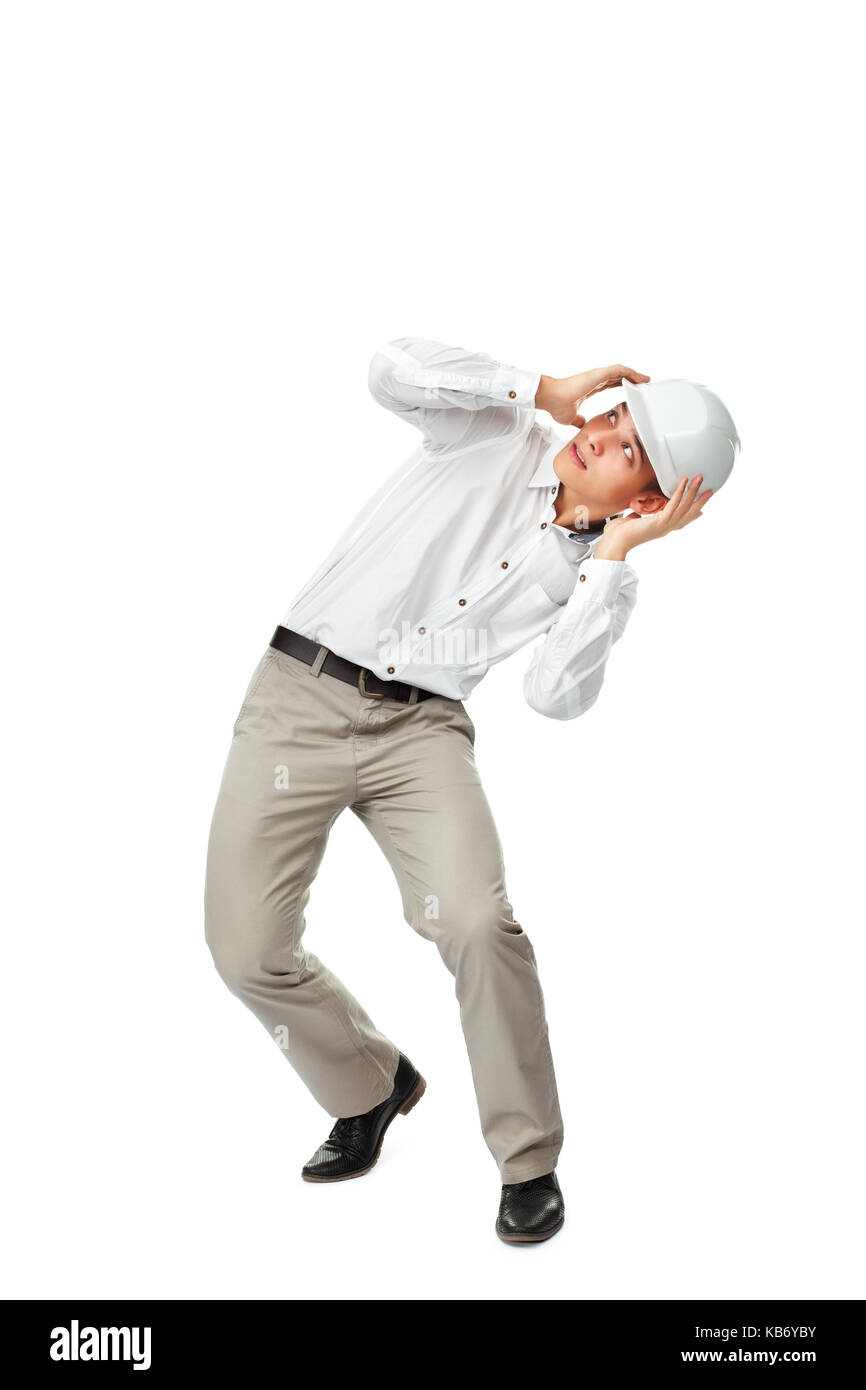 Young engineer defending himself from something on top isolated on ...