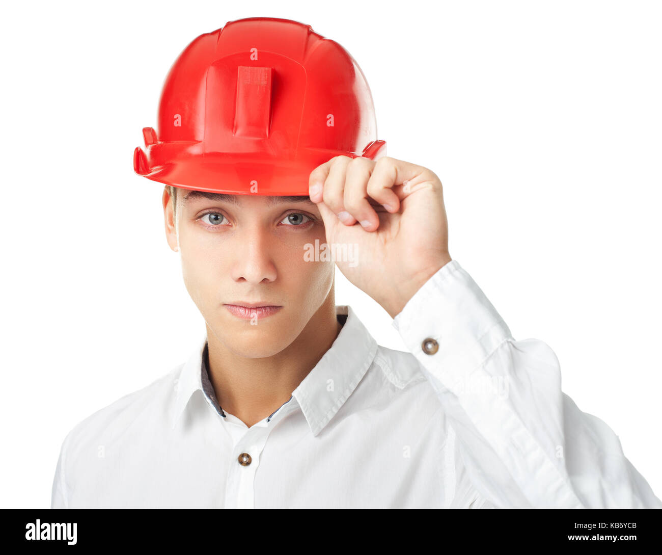 Portrait of young engineer wearing red helmet isolated on white ...