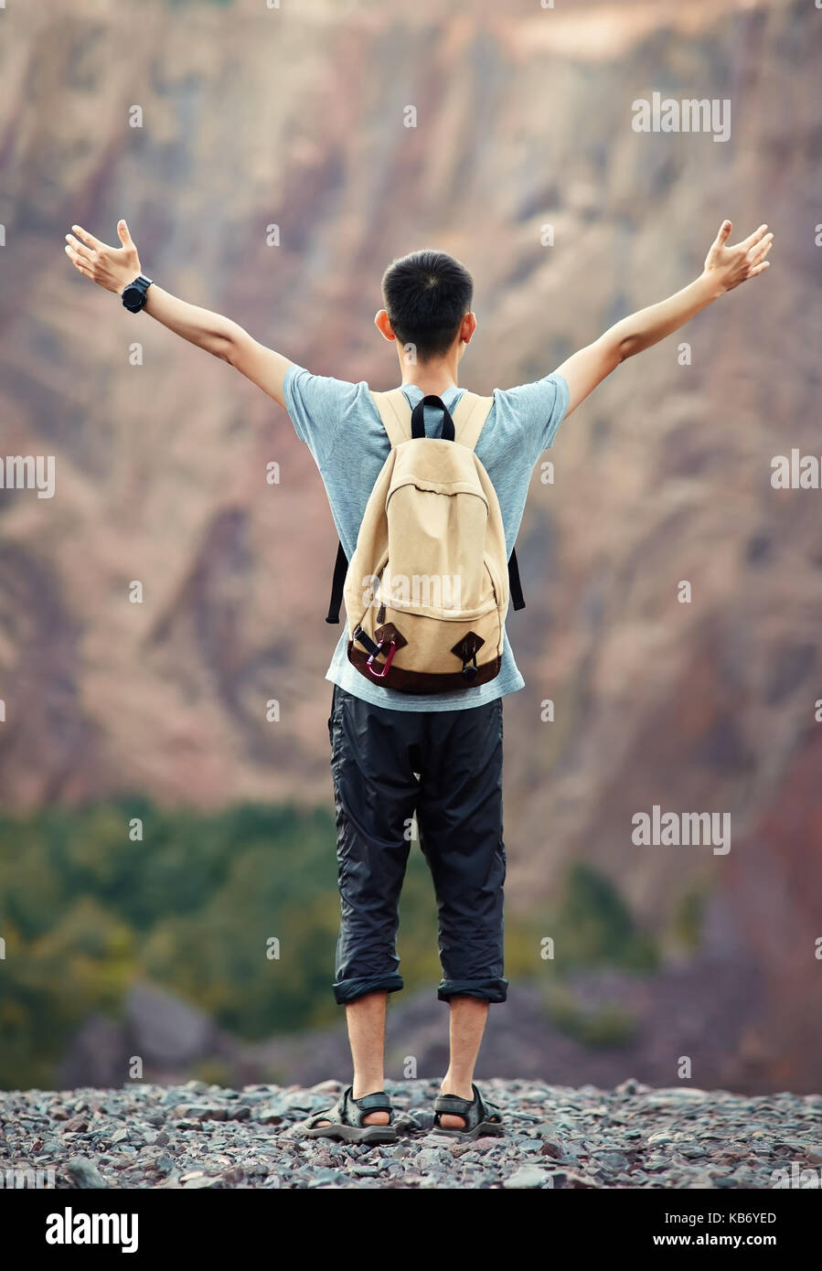 Man looking at mountain hands raised hi-res stock photography and ...