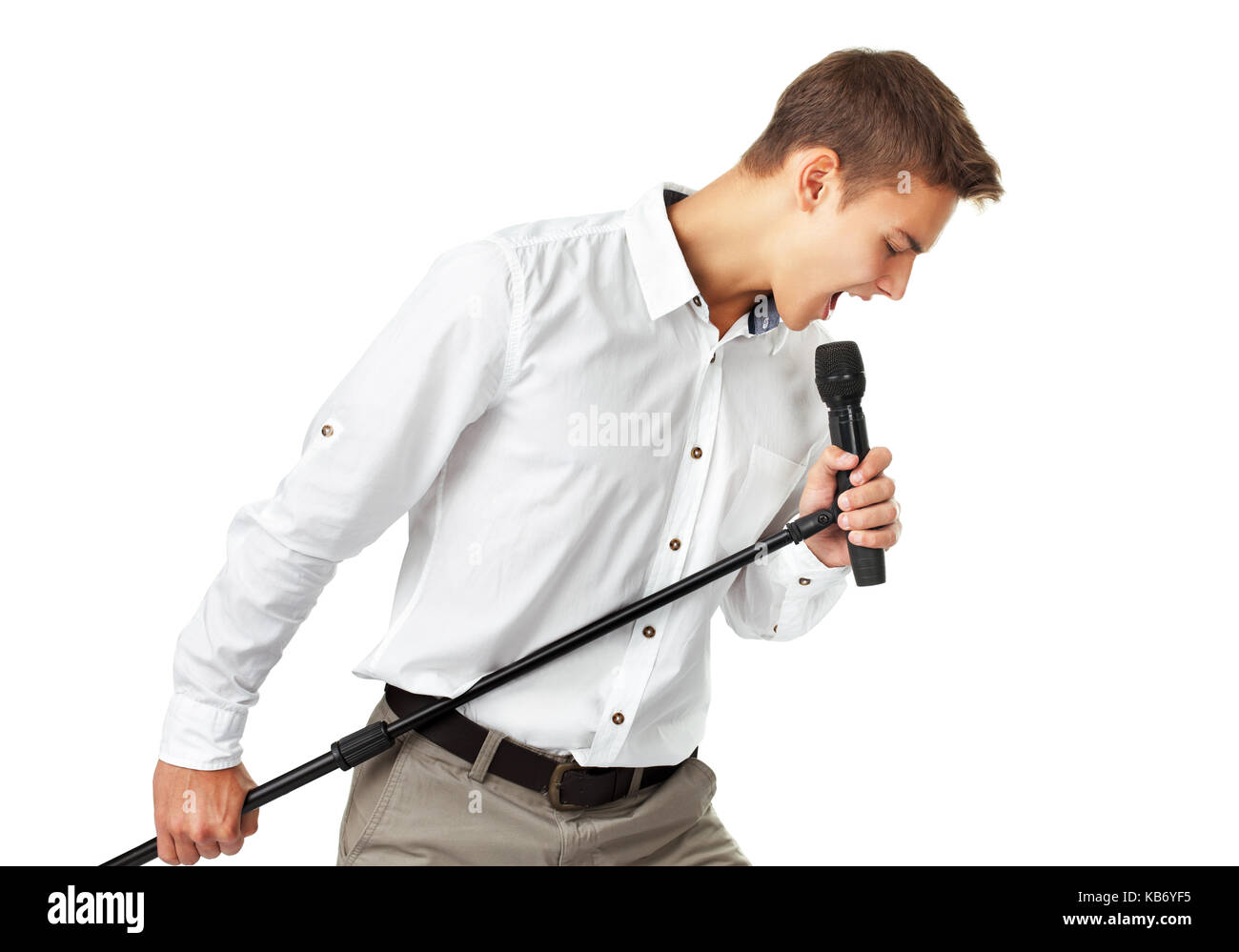 Young man singing into a microphone isolated on white background Stock Photo - Alamy
