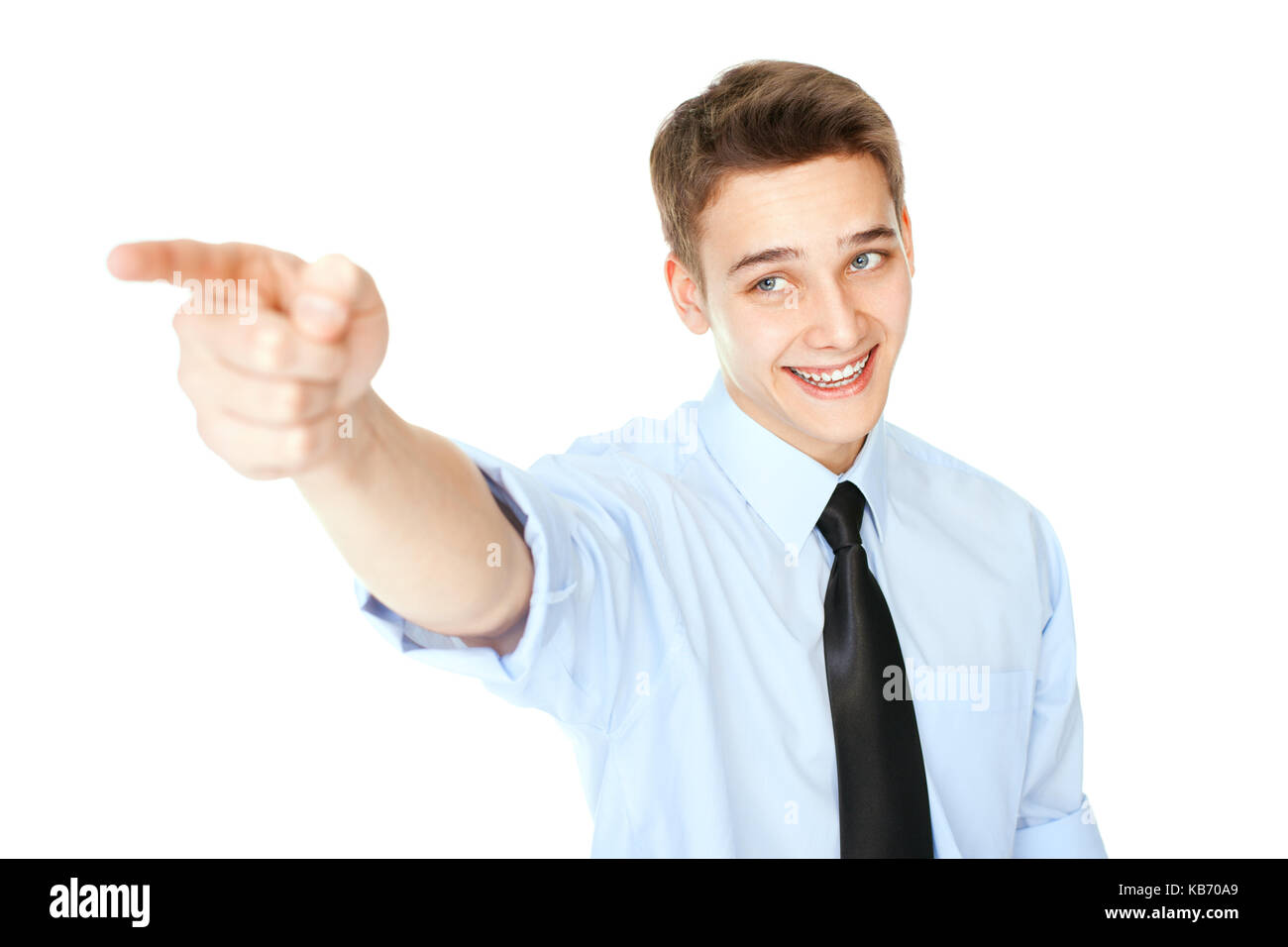 Portrait of young smiling successful businessman pointing finger ...