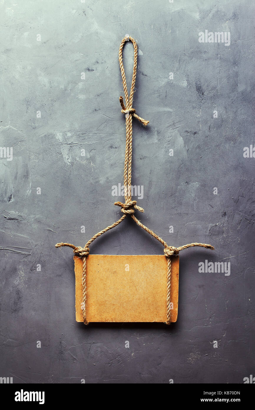 Wooden signboard hanging on rope on gray textured wall Stock Photo - Alamy