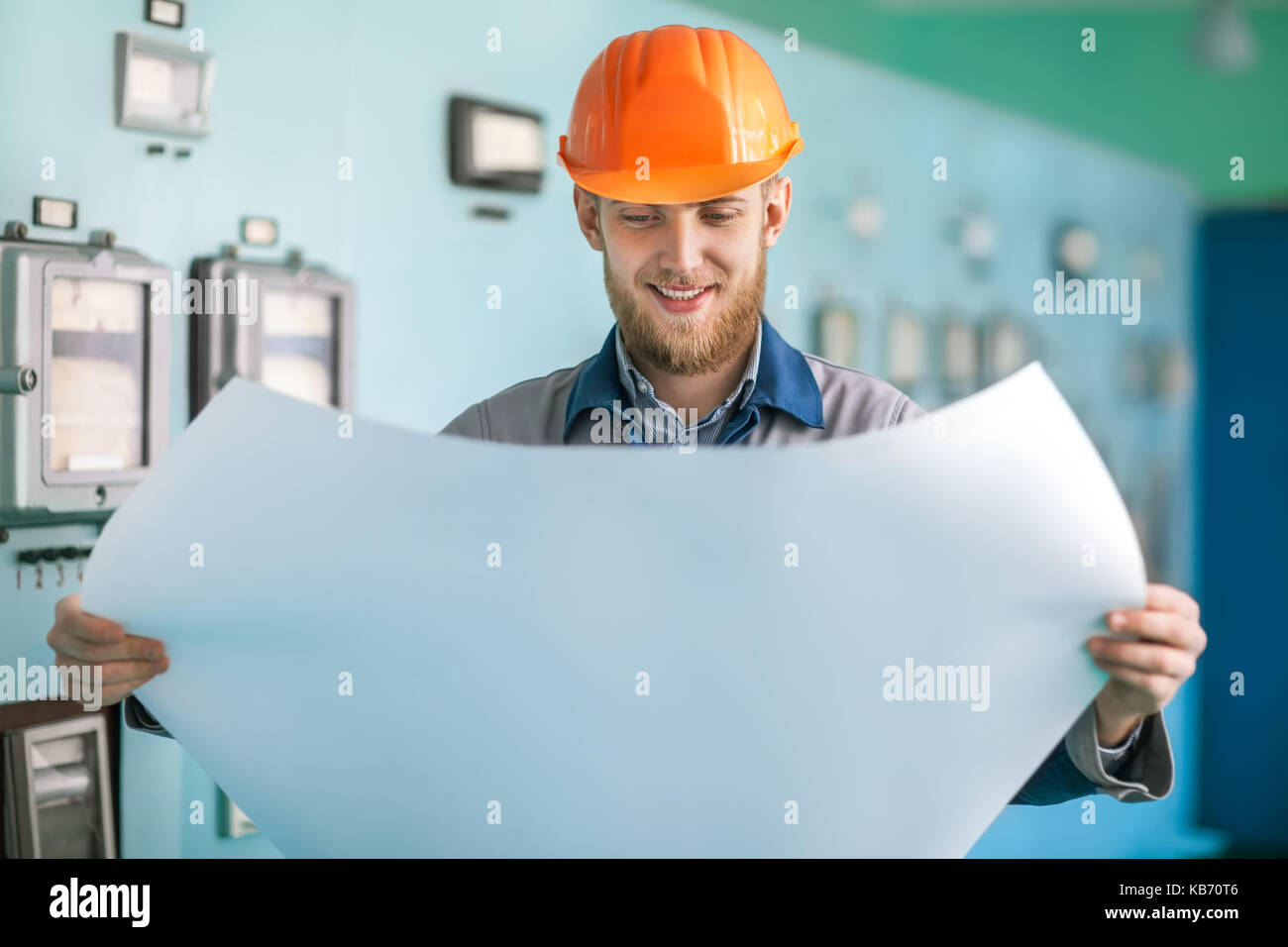 Portrait of young engineer working with blueprint at control room Stock ...