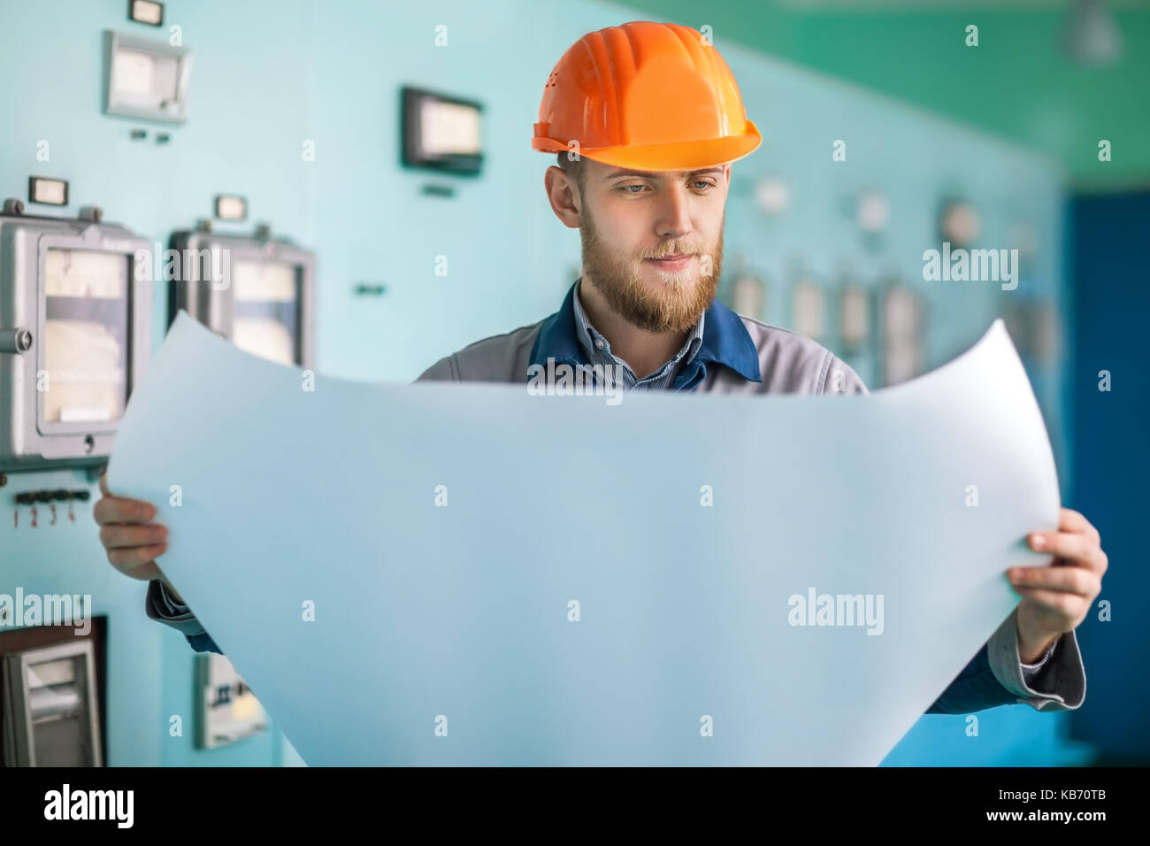 Portrait of young engineer working with blueprint at control room Stock ...