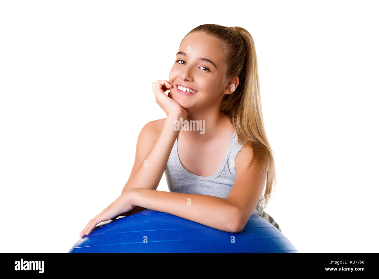 cheerful young girl exercising with exercise ball during workout close ...