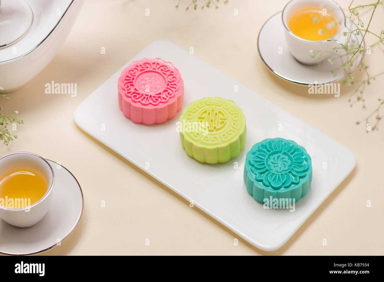 Colorful snow skin mooncake with tea pot on pink background Stock Photo ...