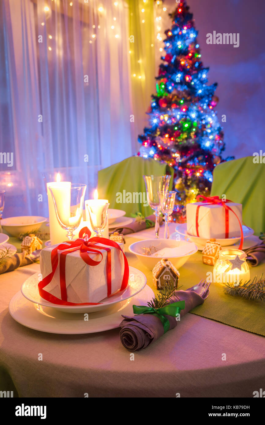 Traditionally Christmas table setting with candles and gingerbread ...