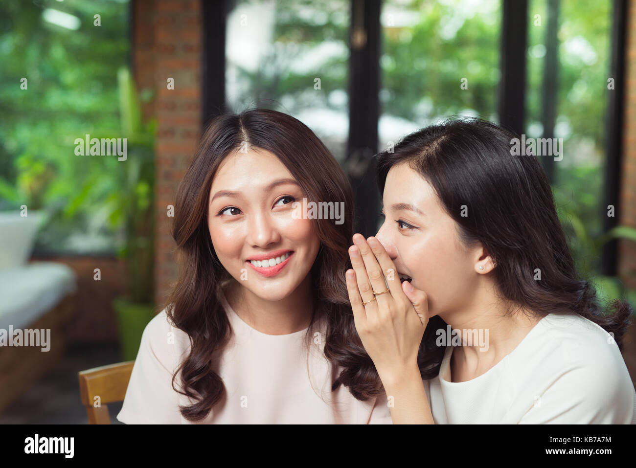 Woman whispering in secret hi-res stock photography and images - Alamy
