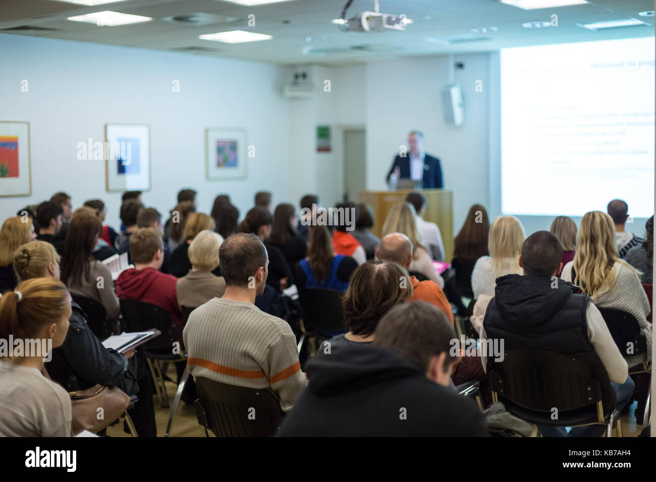 Man giving presentation in lecture hall at university Stock Photo - Alamy